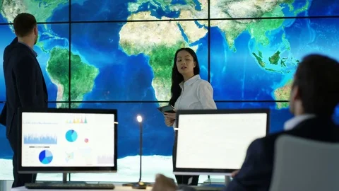 4K Business team discussing large world ... | Stock Video | Pond5