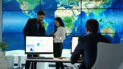 4K Business team discussing large world ... | Stock Video | Pond5