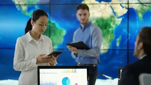 4K Business team discussing large world ... | Stock Video | Pond5