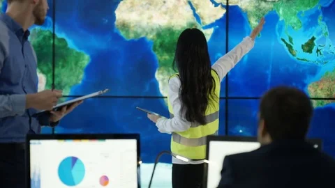 4K Business team discussing large world ... | Stock Video | Pond5