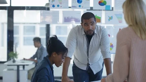 4K Business team in a meeting looking at... | Stock Video | Pond5