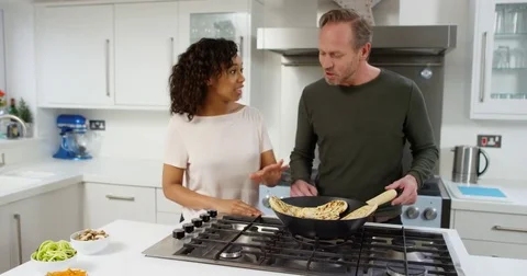 4K Cheerful couple cooking in modern kit... | Stock Video | Pond5