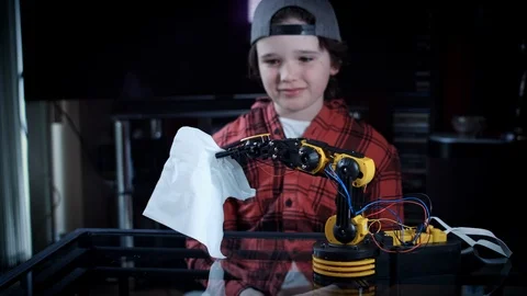 4k Child Boy Lifting Tissue with Robotic... | Stock Video | Pond5