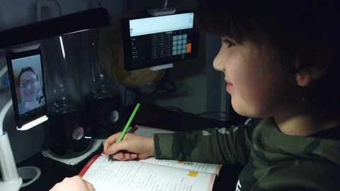 4K Child Doing Homework on Multiple Devi... | Stock Video | Pond5