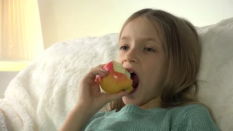 4K Child Eating Apples while Watching TV... | Stock Video | Pond5