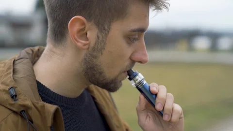 4K Close Up Of a sad man Vaping. Exhalin... | Stock Video | Pond5