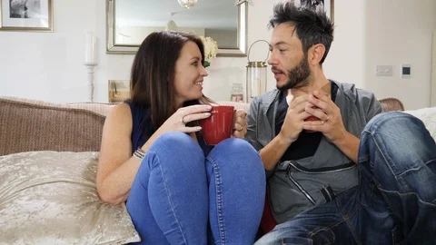 4K: Couple Sitting on the Sofa / couch a... | Stock Video | Pond5