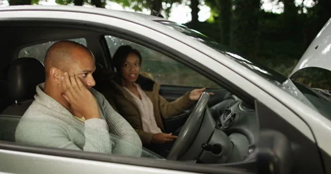 4K Couple stranded in broken down car he... | Stock Video | Pond5