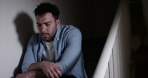 4K Depressed man sitting alone on the st... | Stock Video | Pond5