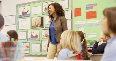 4K Elementary school teacher talking to ... | Stock Video | Pond5