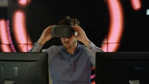 4K Engineer wearing VR viewer at desk wi... | Stock Video | Pond5