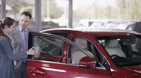 4K Excited couple in car dealership take... | Stock Video | Pond5