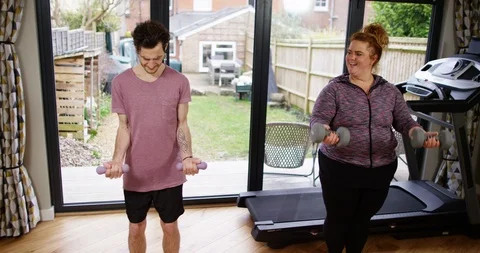 4K Fat happy woman lifting weights & ski... | Stock Video | Pond5