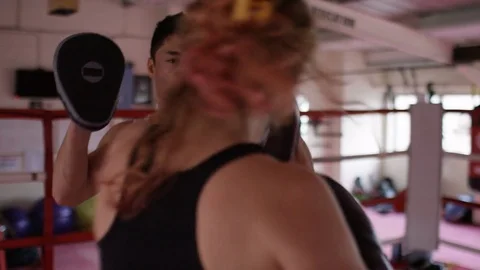 4K Female in a boxing ring doing pad wor... | Stock Video | Pond5