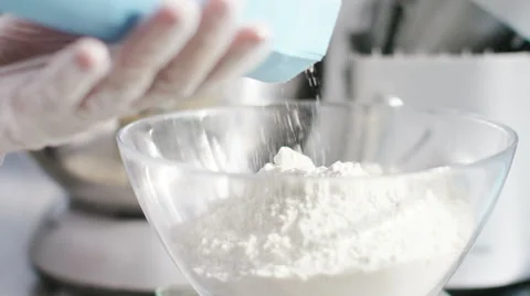 4K Flour being poured into a clear bowl | Stock Video | Pond5