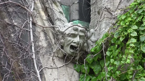 4k gargoyle crying man with climber plan... | Stock Video | Pond5
