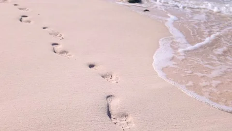 4K Gentle wave near the footprints on th... | Stock Video | Pond5