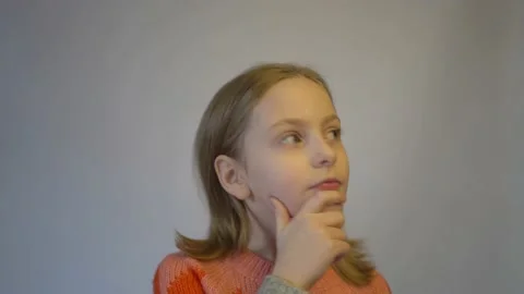 4k Girl thinking choose isolated on whit... | Stock Video | Pond5