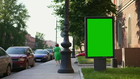 4k Green billboard stands and woman walk... | Stock Video | Pond5