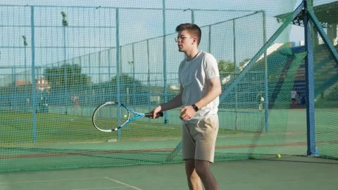 4K. The guy is a tennis player with a ra... | Stock Video | Pond5