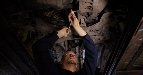 4K Handsome mechanic doing repairs to un... | Stock Video | Pond5