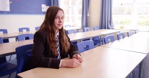 4K Happy young girl sitting alone in sch... | Stock Video | Pond5