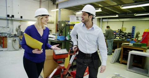 4K Industrial workers talking as they wa... | Stock Video | Pond5