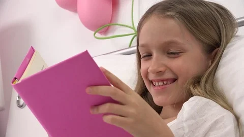 4K Laughing Child Portrait Reading Book,... | Stock Video | Pond5