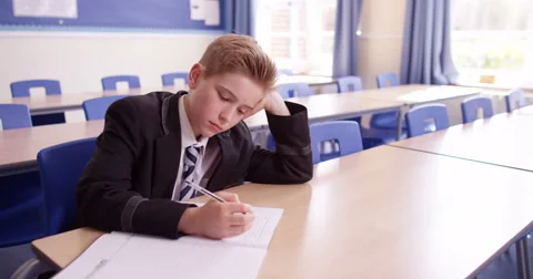 4K Little boy sitting alone to do his wo... | Stock Video | Pond5