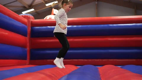 4K: Little girl jumping across a red an... | Stock Video | Pond5