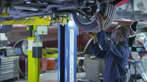 4K Male and female mechanics working und... | Stock Video | Pond5