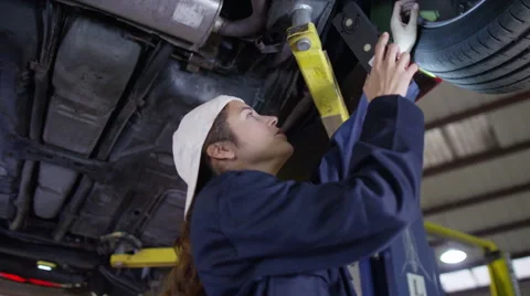 4K Male and female mechanics working und... | Stock Video | Pond5