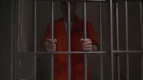4K: Male Prisoner / Inmate behind bars i... | Stock Video | Pond5