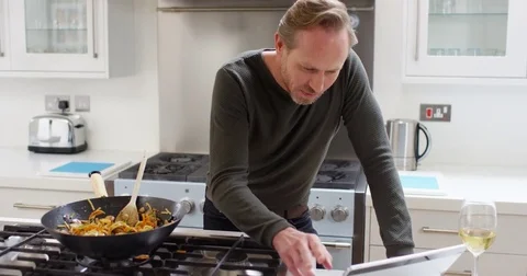 4K Man cooking at home with glass of win... | Stock Video | Pond5