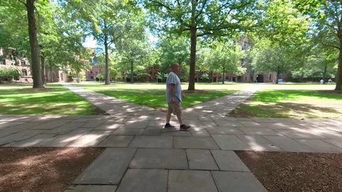 4K Man walking on Campus left to right | Stock Video | Pond5