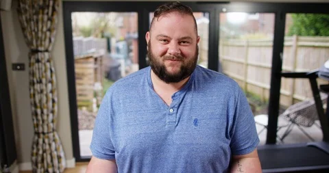 4K Overweight man looking at camera & st... | Stock Video | Pond5