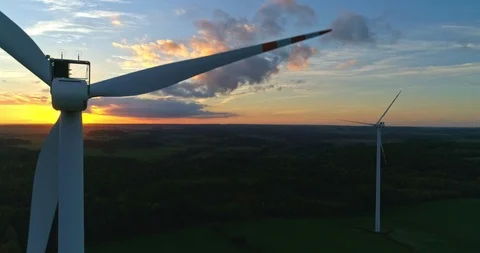 4k Pan of Wind Turbines at Sunset, Produ... | Stock Video | Pond5