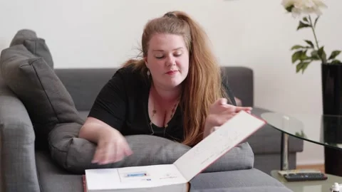 [4k] plus size girl lie on comfy couch r... | Stock Video | Pond5