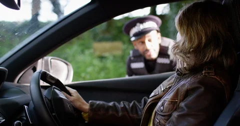 4K Police officer talking to female driv... | Stock Video | Pond5