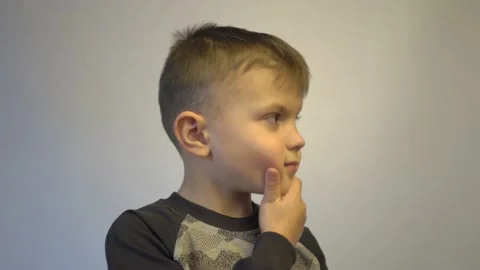 4k Portrait of cute boy thinking isolate... | Stock Video | Pond5