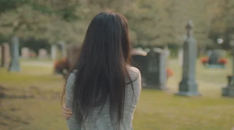 4k - Sad girl walking in cemetery | Stock Video | Pond5