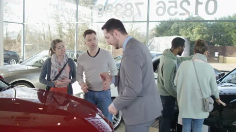4K Salesman in car dealership with coupl... | Stock Video | Pond5