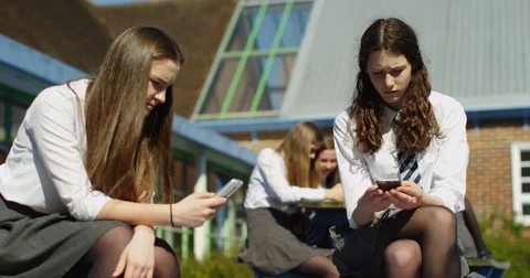 4K School girls with smartphones outside... | Stock Video | Pond5