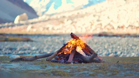 4K shot of bonfire in front of the river... | Stock Video | Pond5