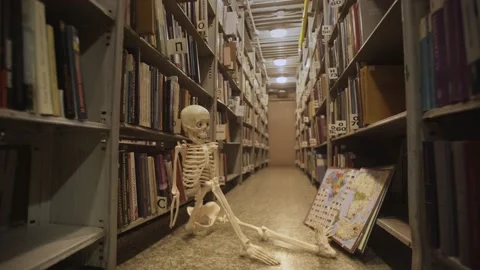 4K. A skeleton in the library with old b... | Stock Video | Pond5