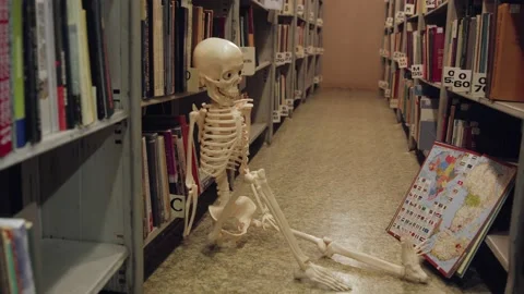 4K. A skeleton in the library with old b... | Stock Video | Pond5