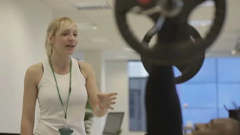 4K Smiling personal trainer helping clie... | Stock Video | Pond5