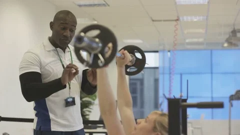 4K Smiling personal trainer helping clie... | Stock Video | Pond5