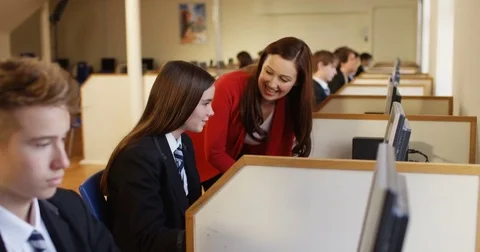 4k, Teacher helping a girl in a computer... | Stock Video | Pond5