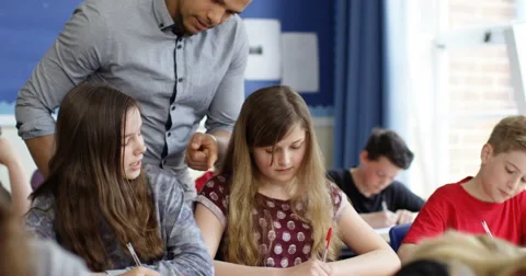 4k, A teacher helping his students with ... | Stock Video | Pond5
